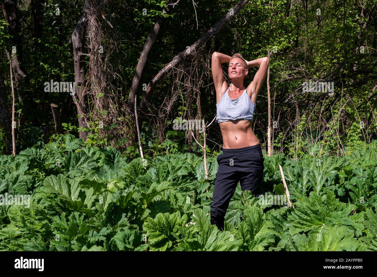A woman in nature, in tall grass Stock Photo - Alamy