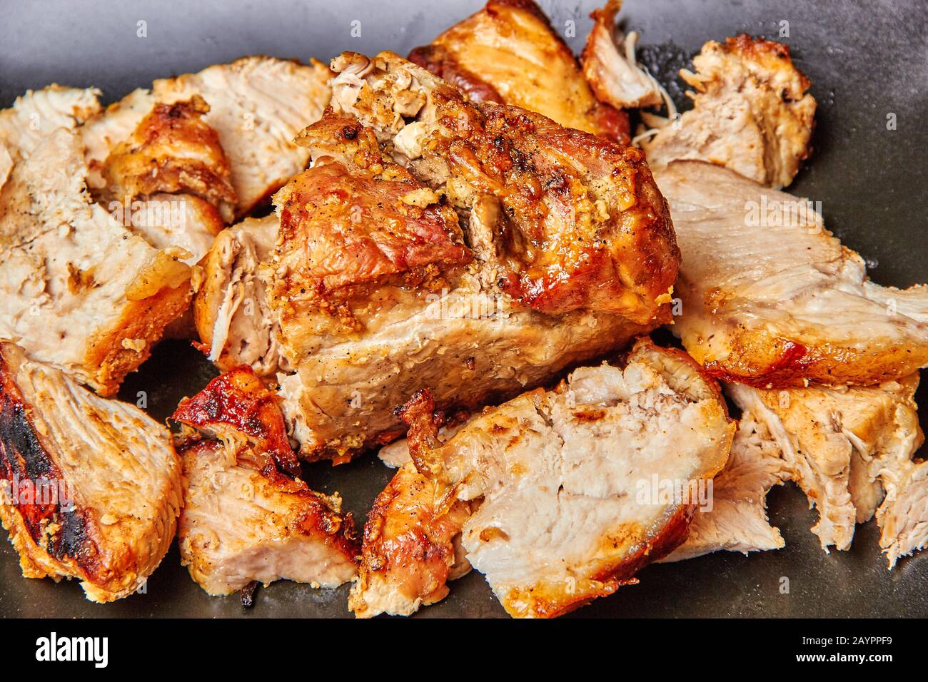 baked meat cut into pieces close up photo Stock Photo - Alamy
