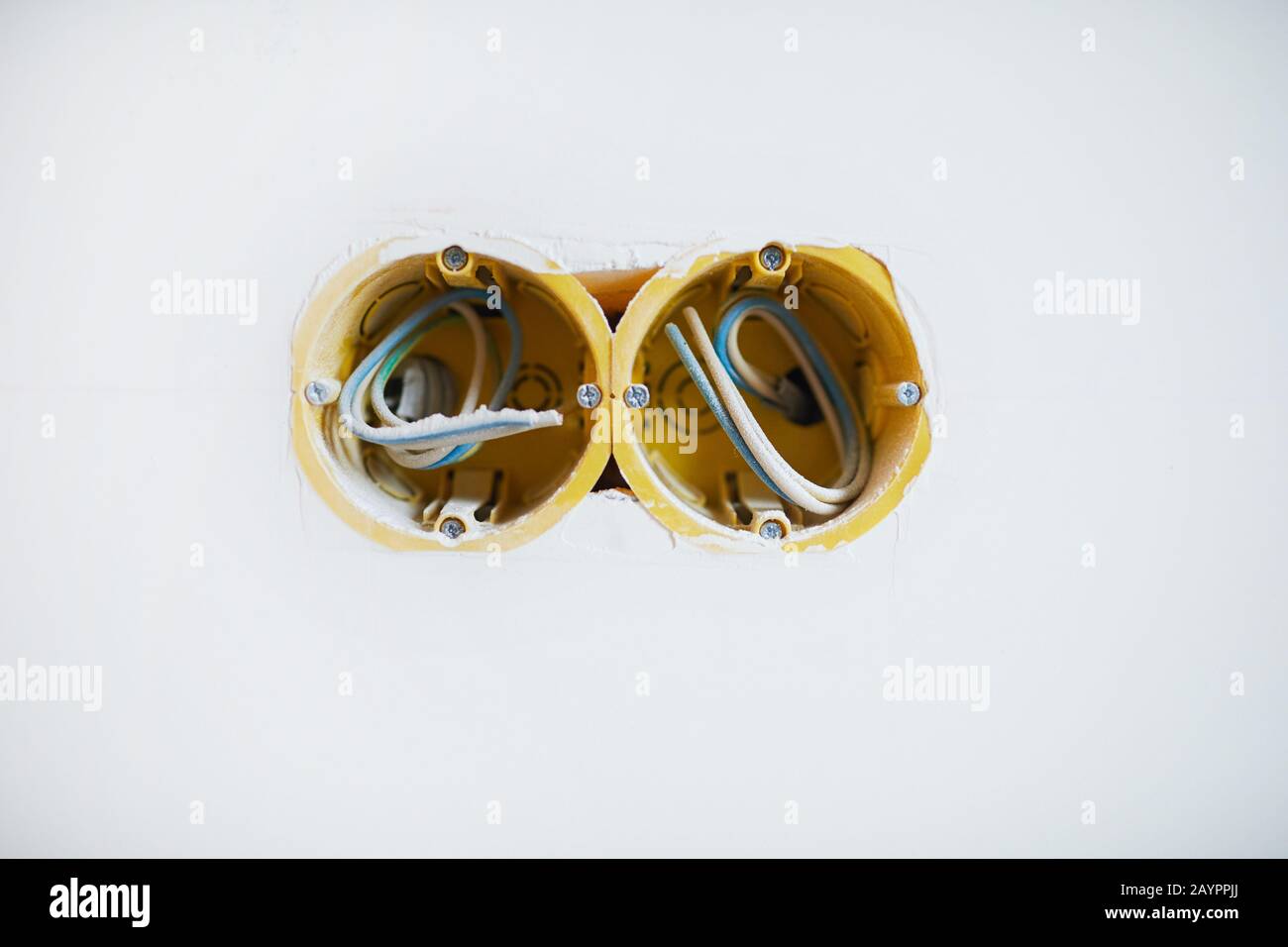 Background image of wired socket box in white wall, construction or ...