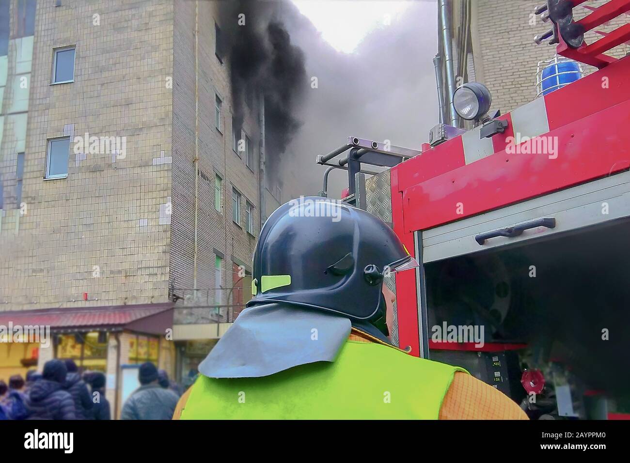 firefighter in front of a fire in a high-rise trade building, fighting ...