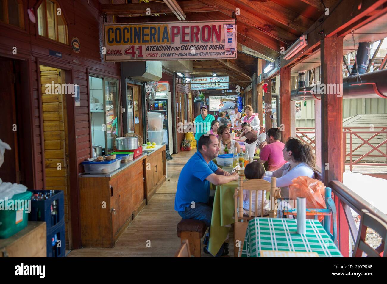 People eating seafood at the small restaurants in the market hall in ...