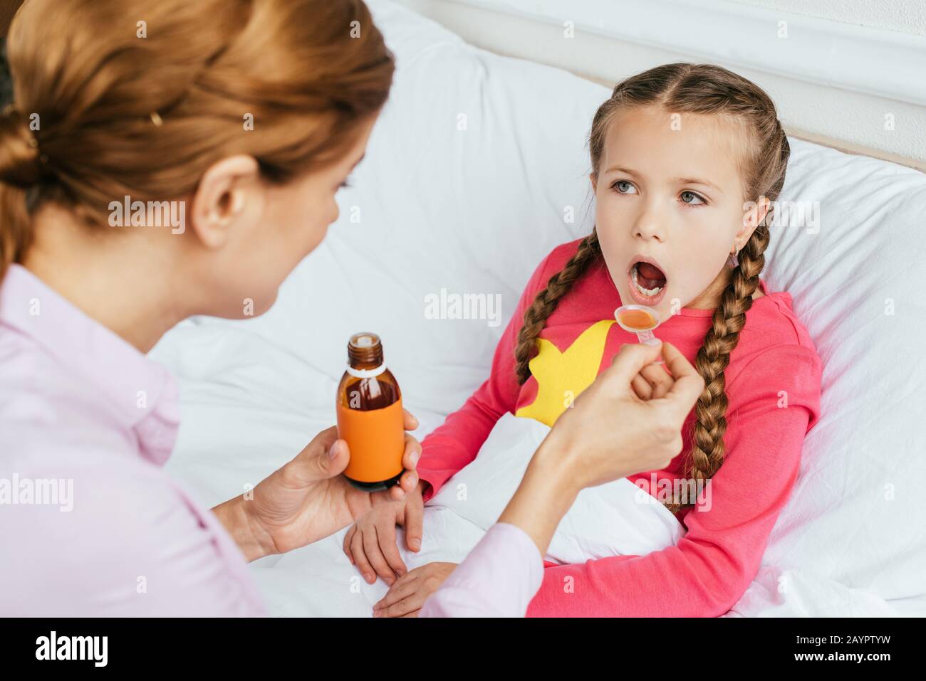 Mother giving syrup daughter hi-res stock photography and images - Alamy