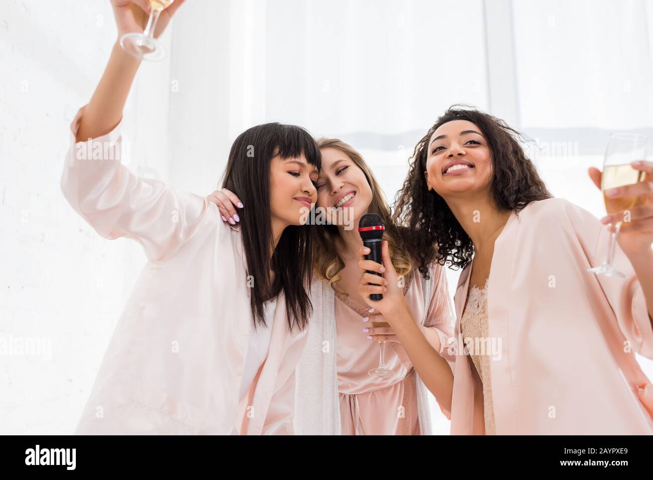 Beautiful young woman singing karaoke Stock Photo - Alamy