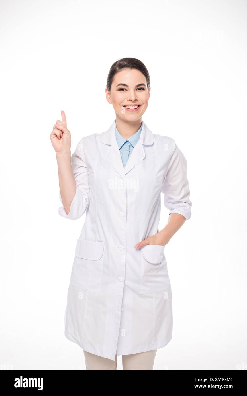 Beautiful doctor smiling at camera and pointing with finger isolated on ...