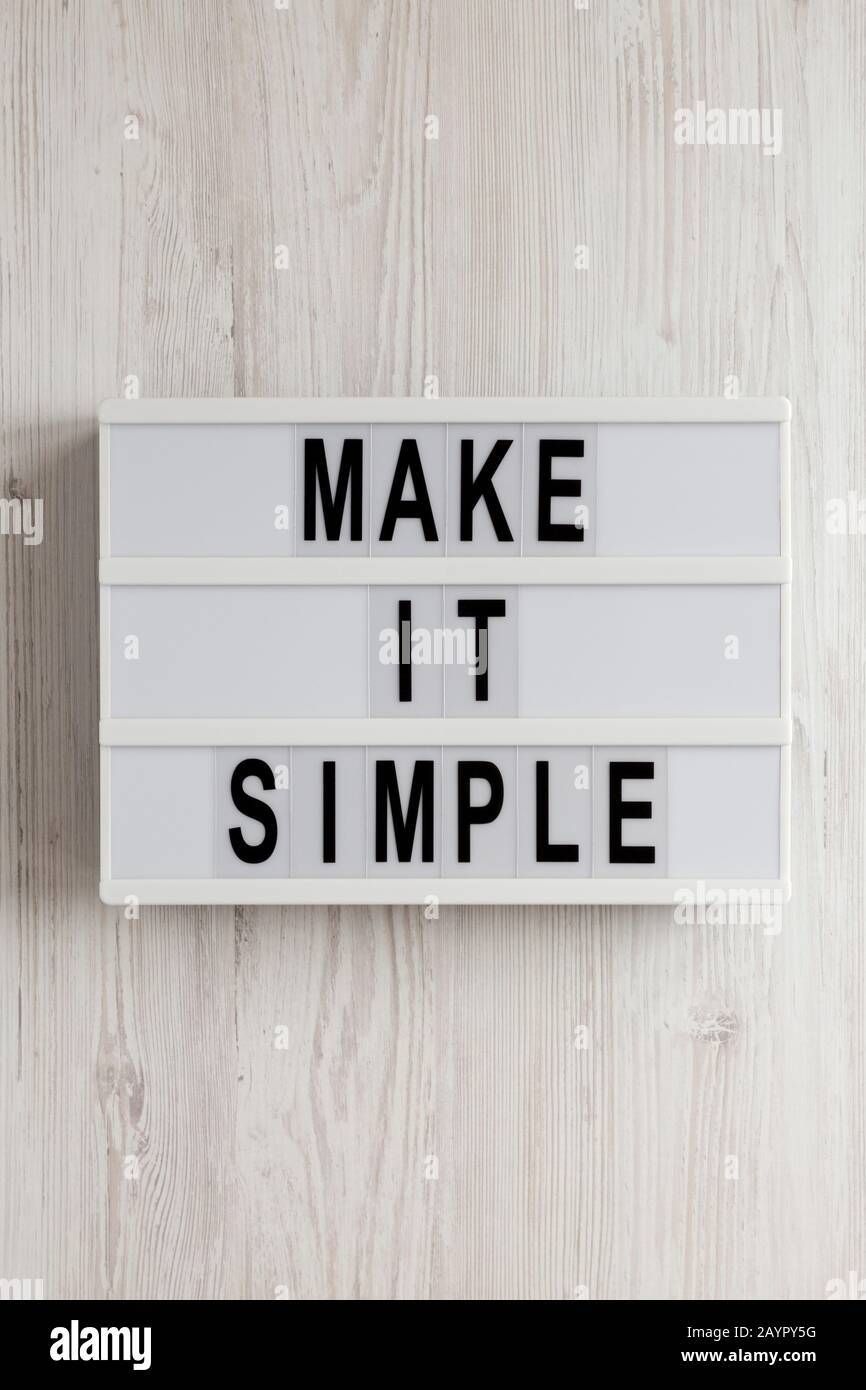 'Make it simple' words on a lightbox on a white wooden background ...