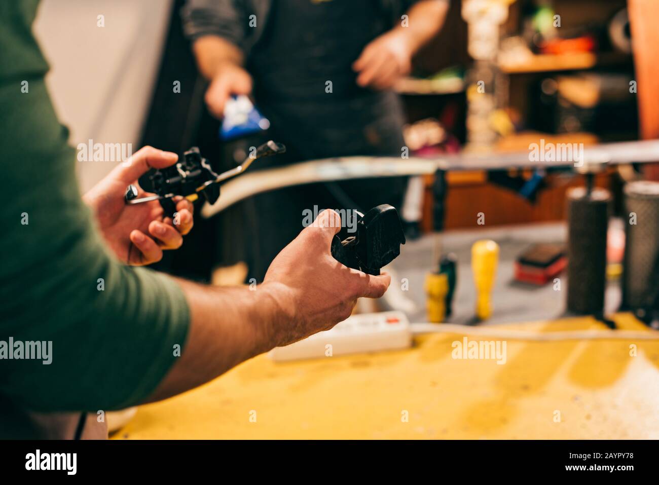 cropped view of worker holding grip vices in repair shop Stock Photo ...