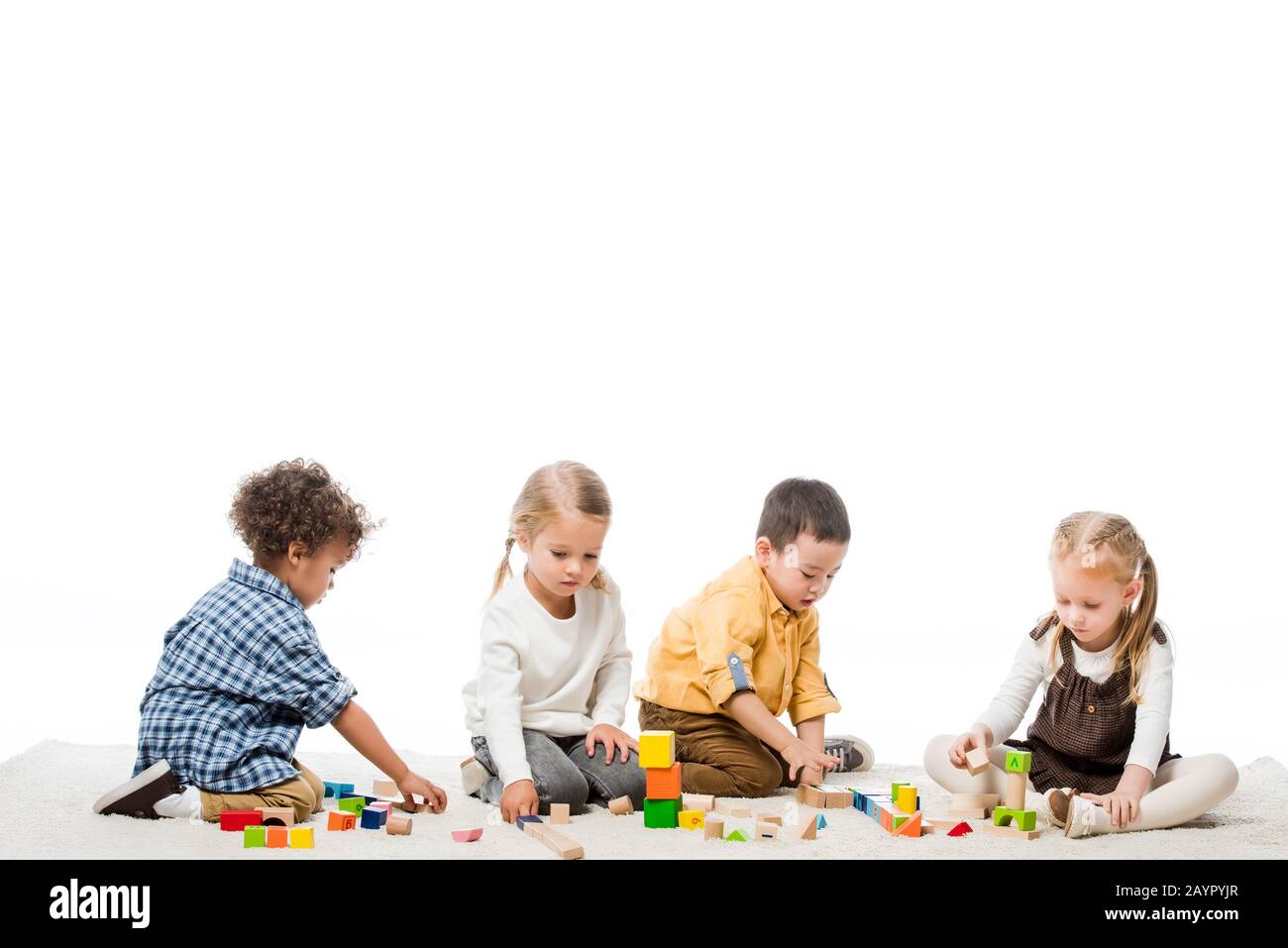 multicultural children playing with wooden blocks on carpet, isolated ...