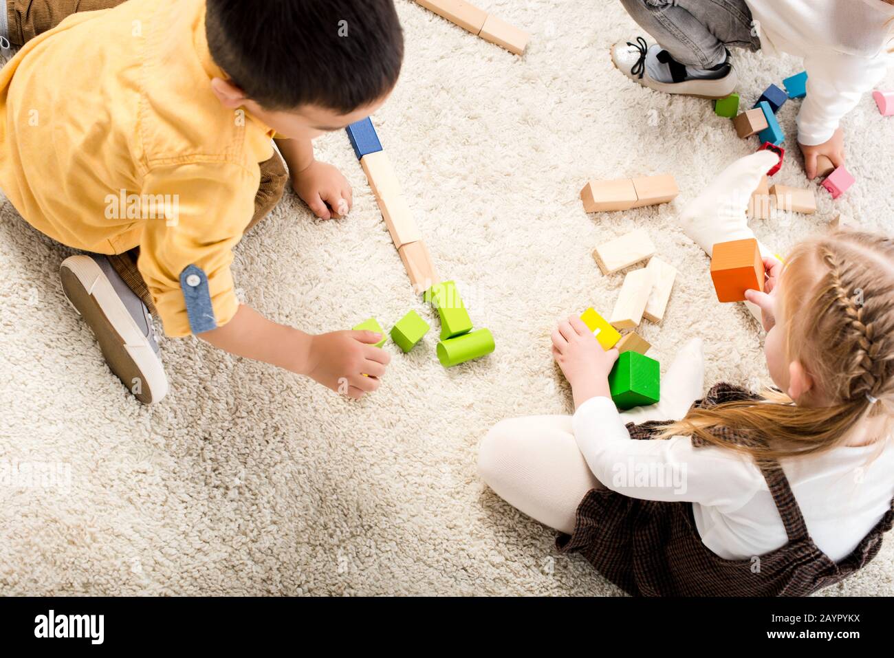 Adorable kids playing together blocks hi-res stock photography and ...