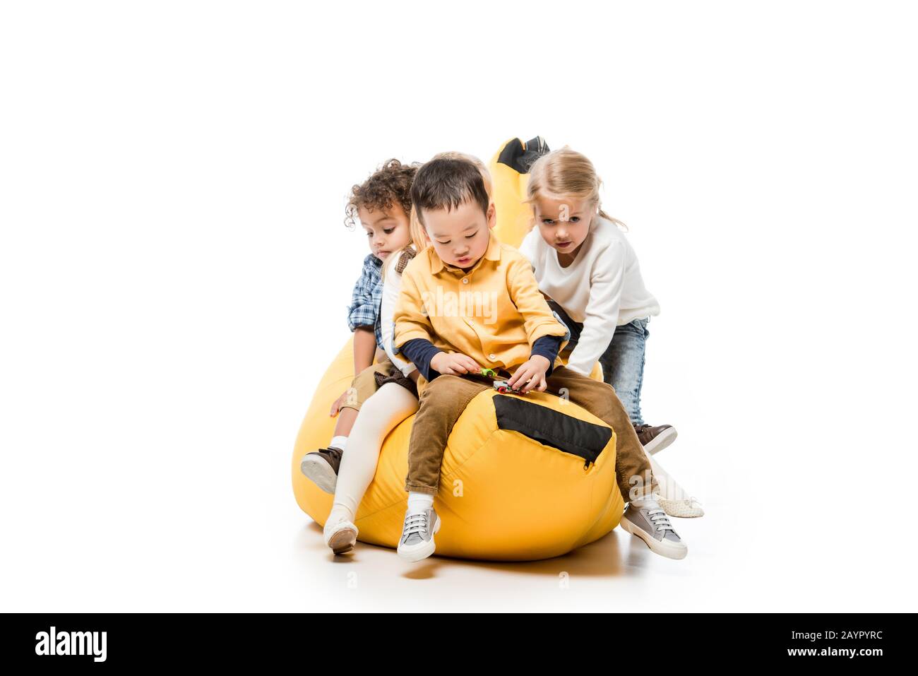 funny multicultural kids sitting on bin bag chair on white Stock Photo ...