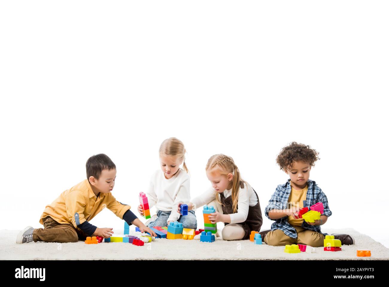 multicultural children playing with wooden blocks on carpet, isolated ...