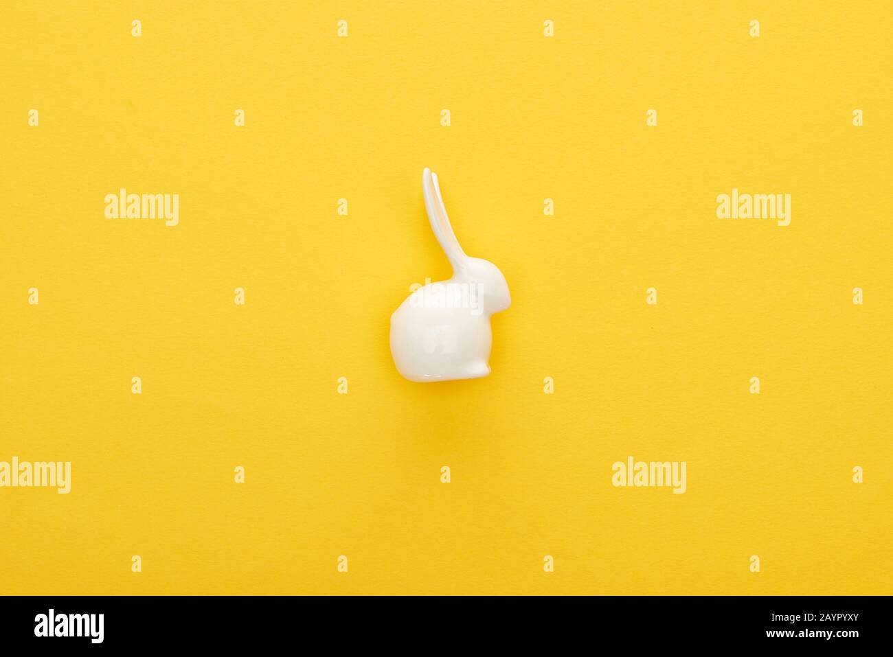 top view of white Easter bunny on colorful yellow background Stock ...