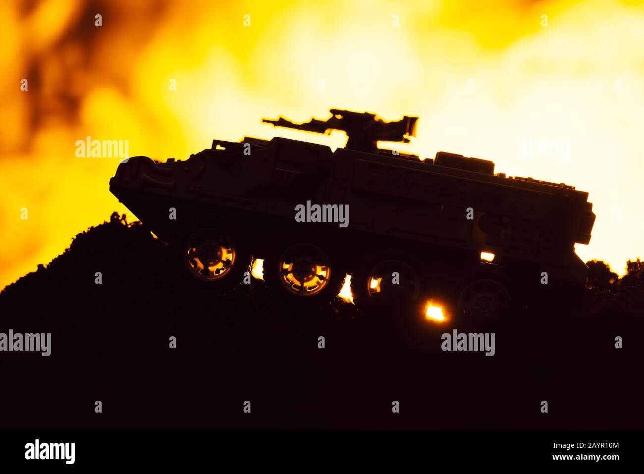 Battle scene with toy tank and fire at background Stock Photo - Alamy