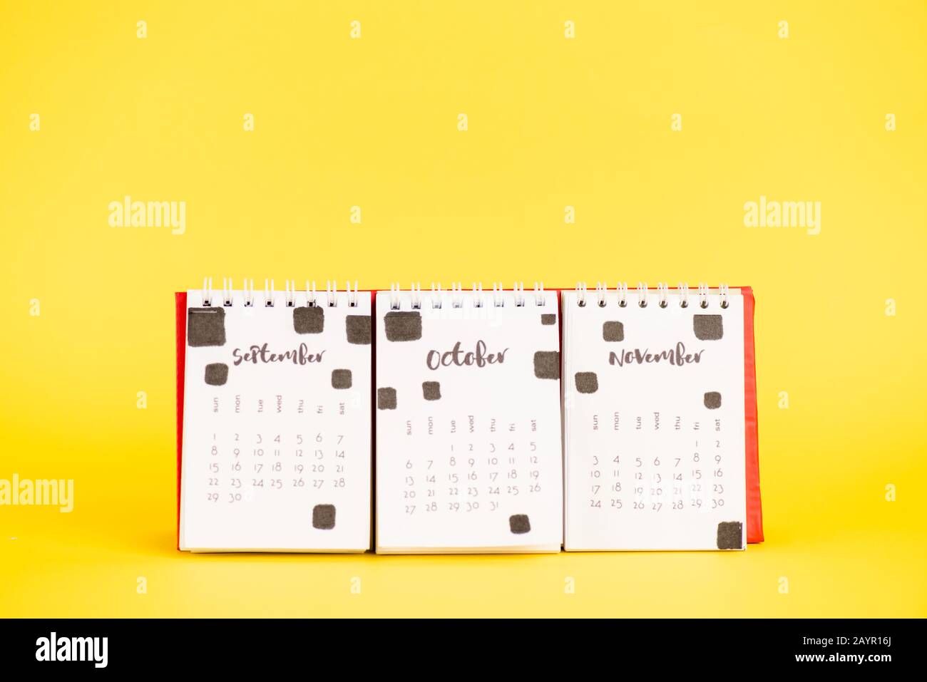 Paper calendar with september, october and november months on yellow ...