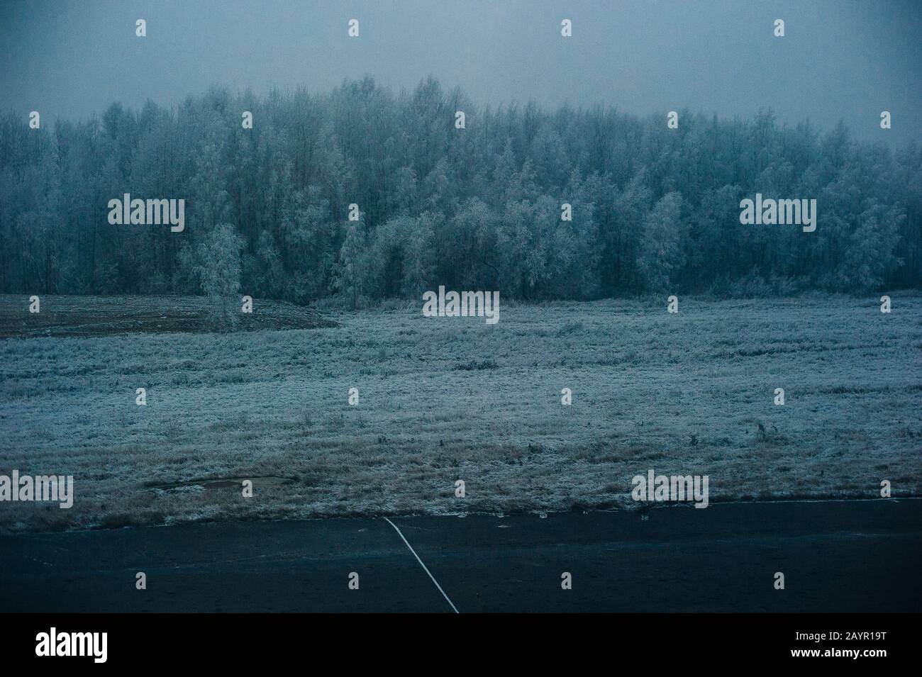 Airport and winter runway, view from a height to a snow-covered ...