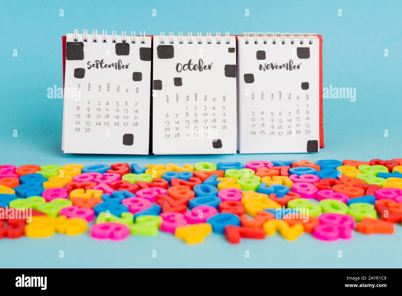 Calendar and colorful plastic numbers on blue background Stock Photo ...