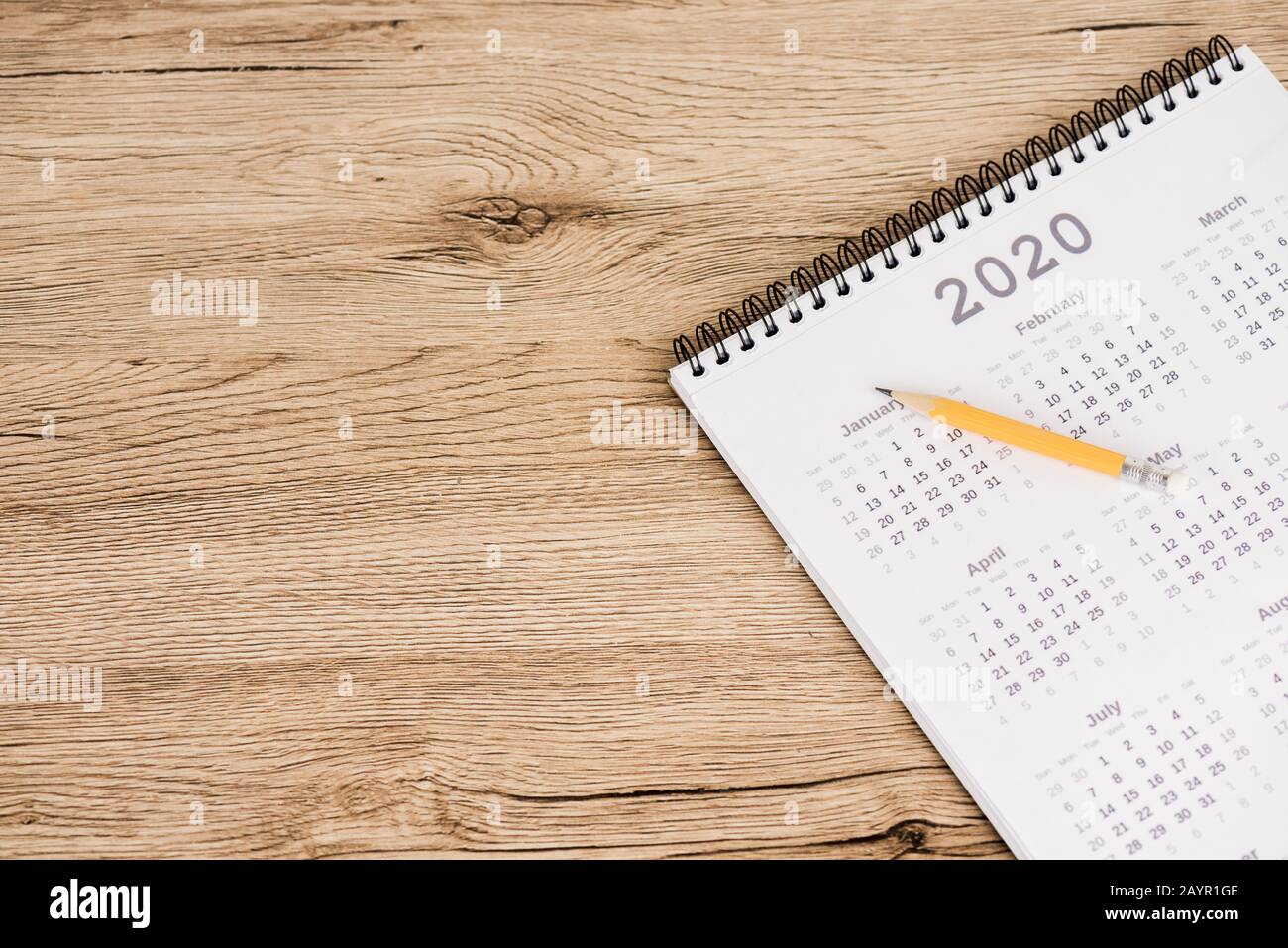 High angle view of calendar of 2020 year and pencil on wooden ...