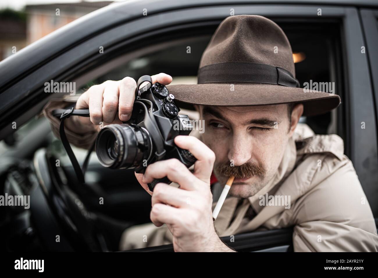 Spy or paparazzo photographer, detective using camera in his car Stock ...