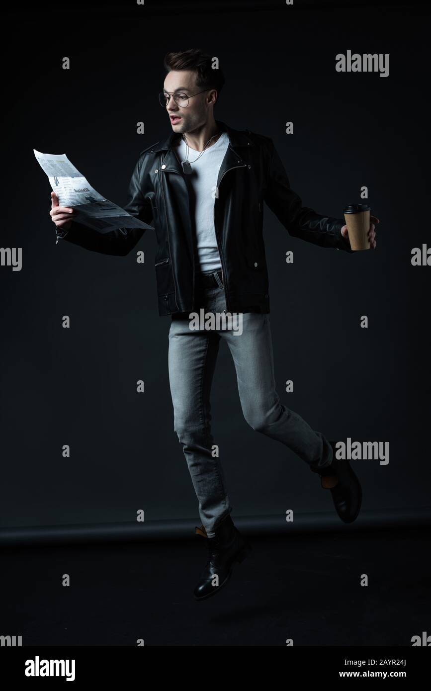 shocked stylish brutal man in biker jacket levitating with paper cup ...