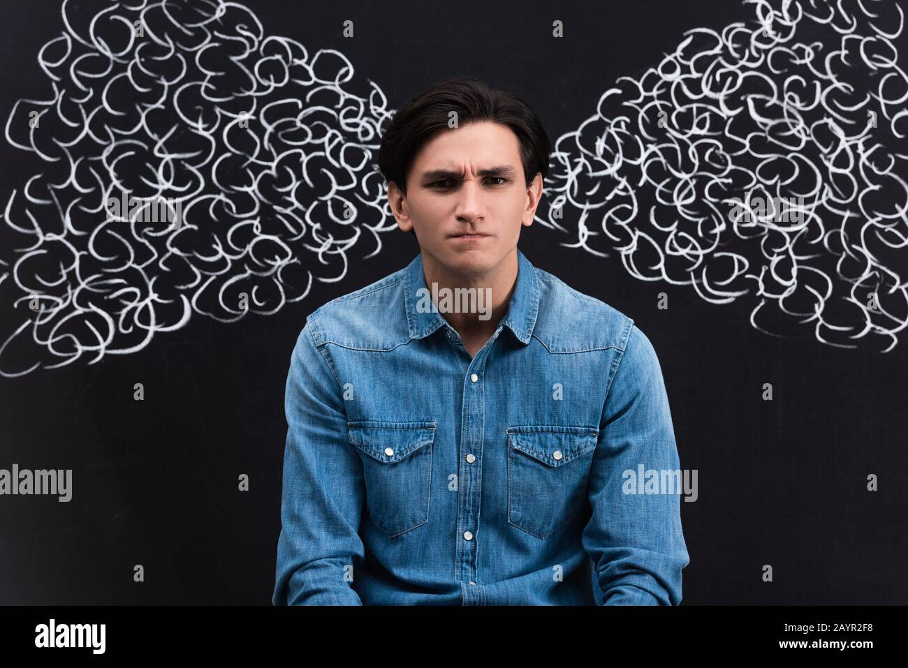 aggressive young man with steam drawing on blackboard behind Stock ...