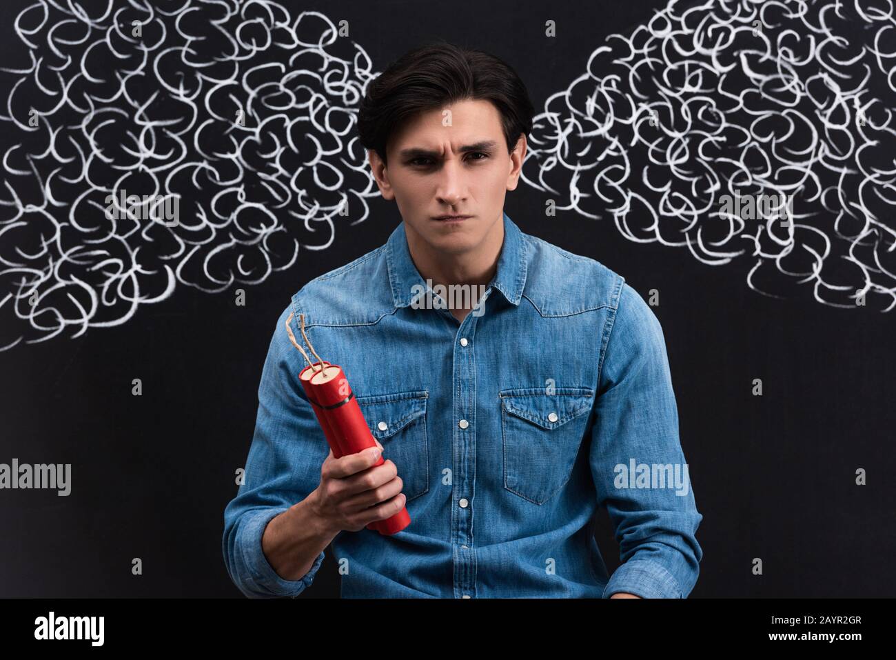 angry young man holding dynamite, with steam drawing on chalkboard ...