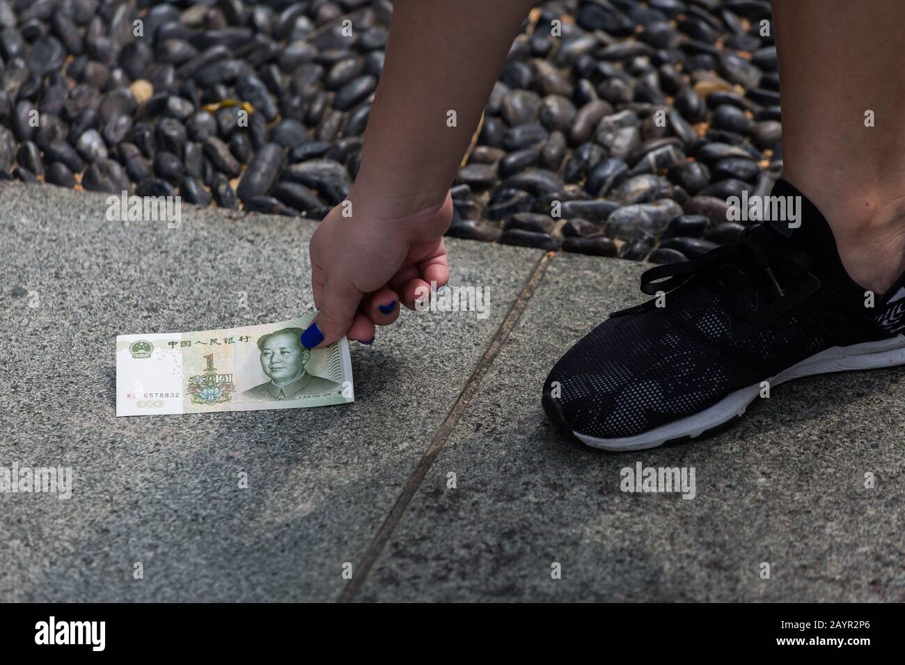 Picking up 1 RMB China money note on the floor Stock Photo - Alamy