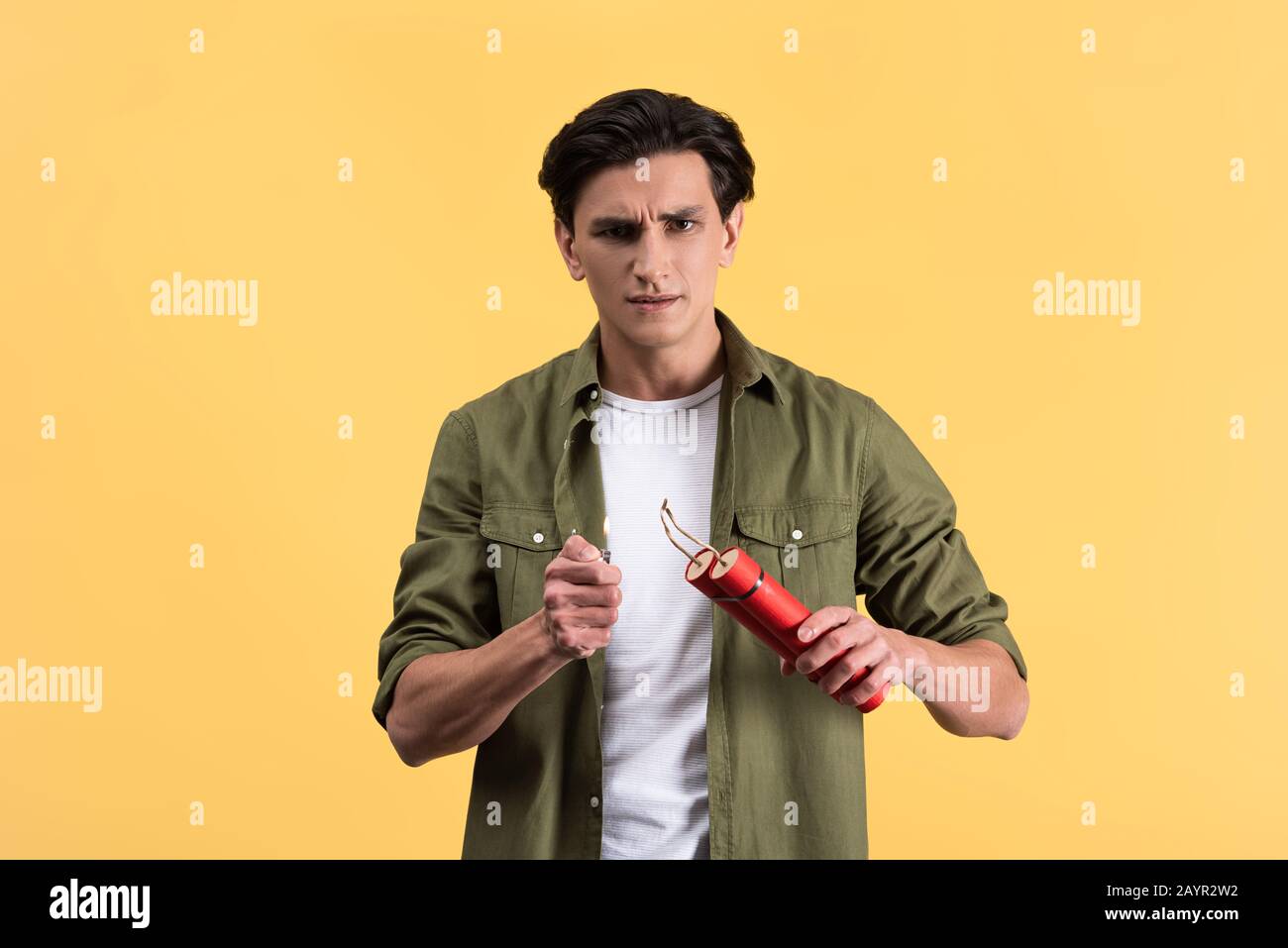 angry man holding dynamite sticks and lighter, isolated on yellow Stock ...