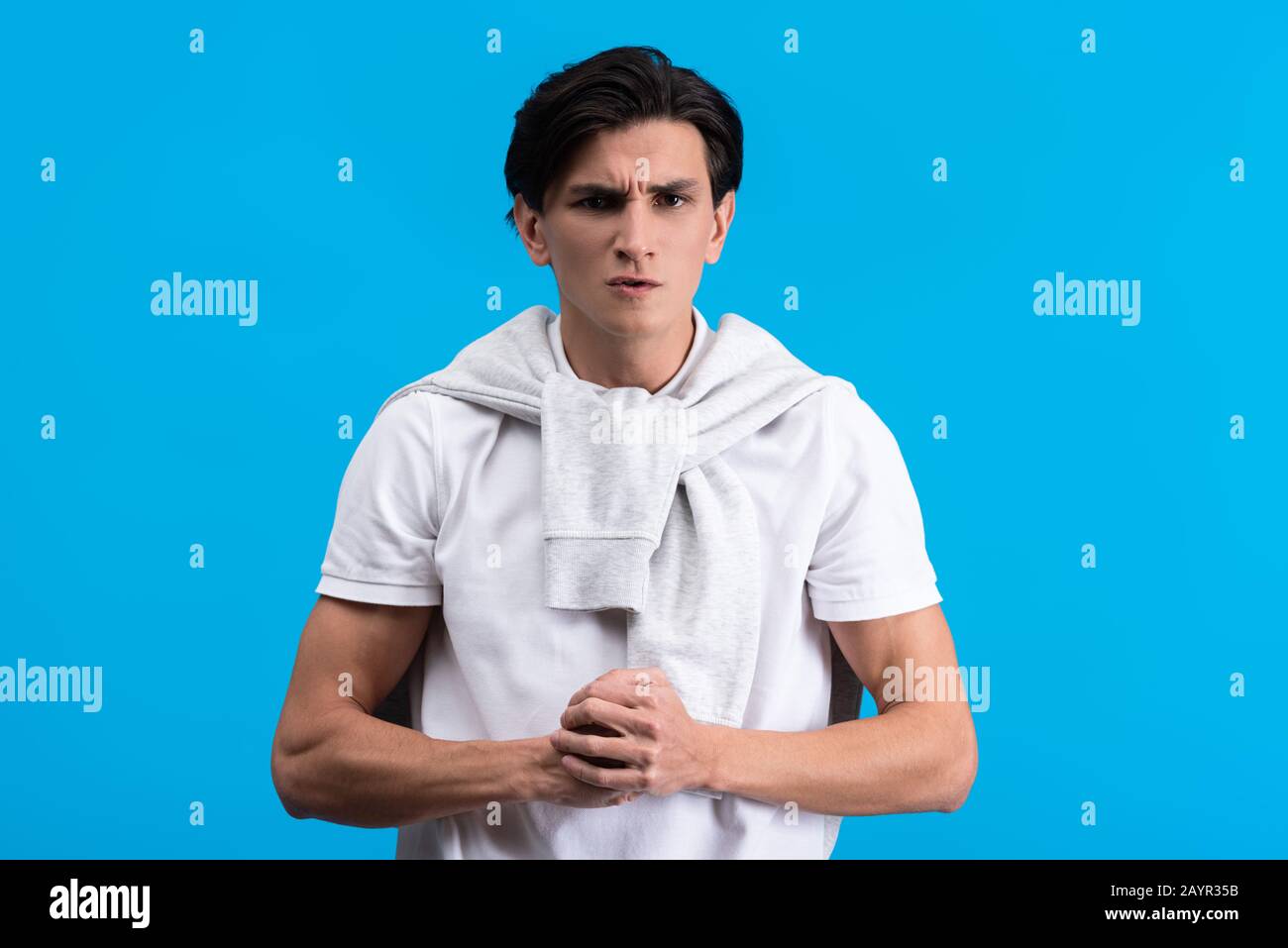 aggressive handsome young man, isolated on blue Stock Photo - Alamy