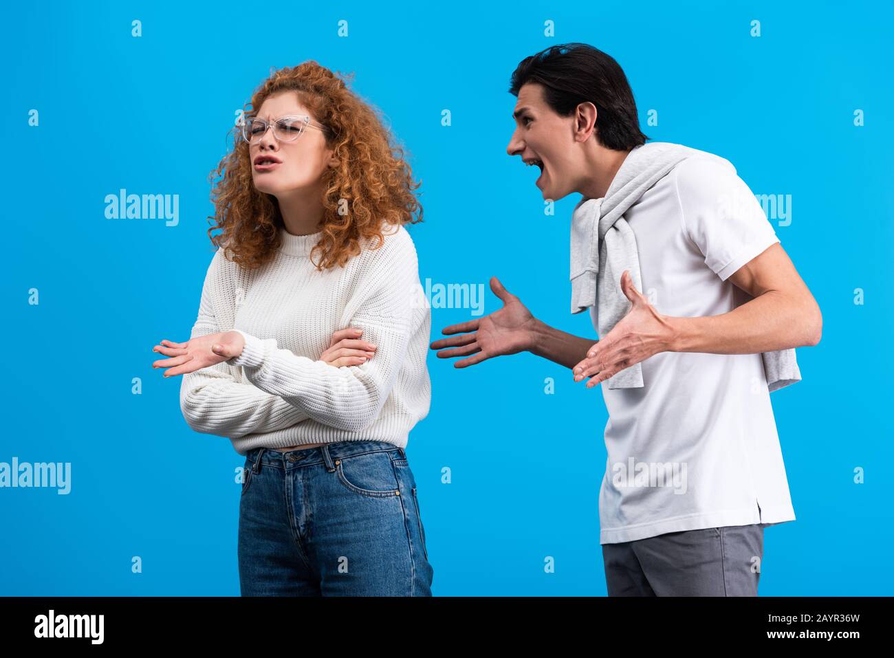 angry boyfriend yelling at irritated girlfriend, isolated on blue Stock ...