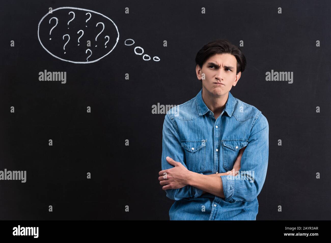 Young man thinking question marks hi-res stock photography and images ...