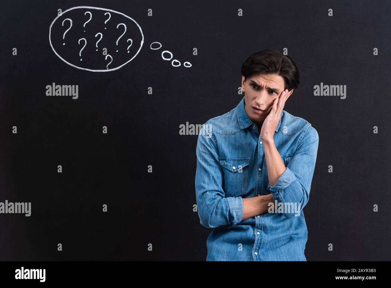 Young man thinking question marks hi-res stock photography and images ...