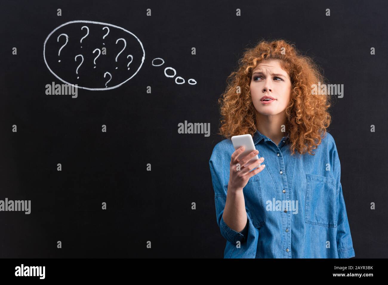 attractive thoughtful woman using smartphone, question marks in thought ...