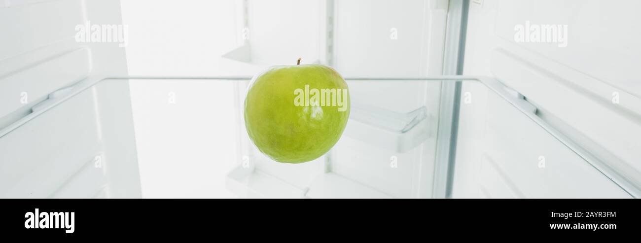 Fresh green apple in refrigerator with open door isolated on white ...