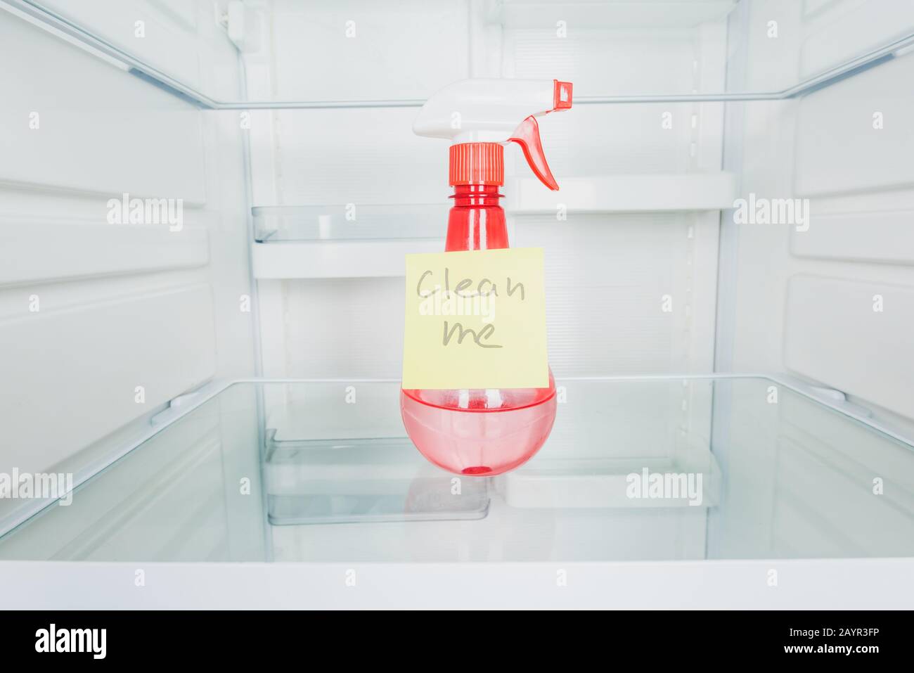 Bottle of detergent with clean me lettering on card on refrigerator ...