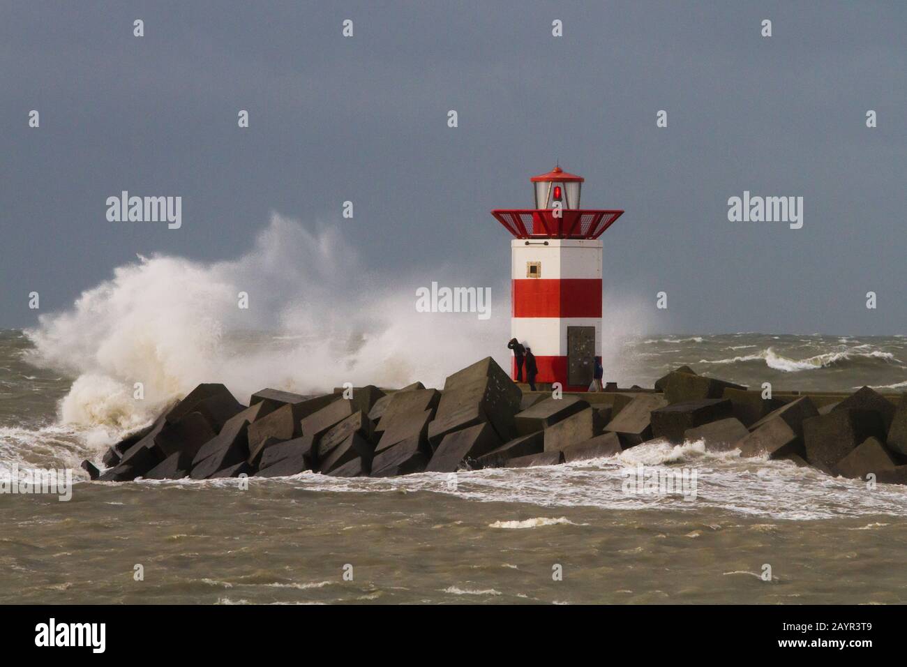 Lighthouse on jetty during storm, Netherlands, Scheveningen Stock Photo ...