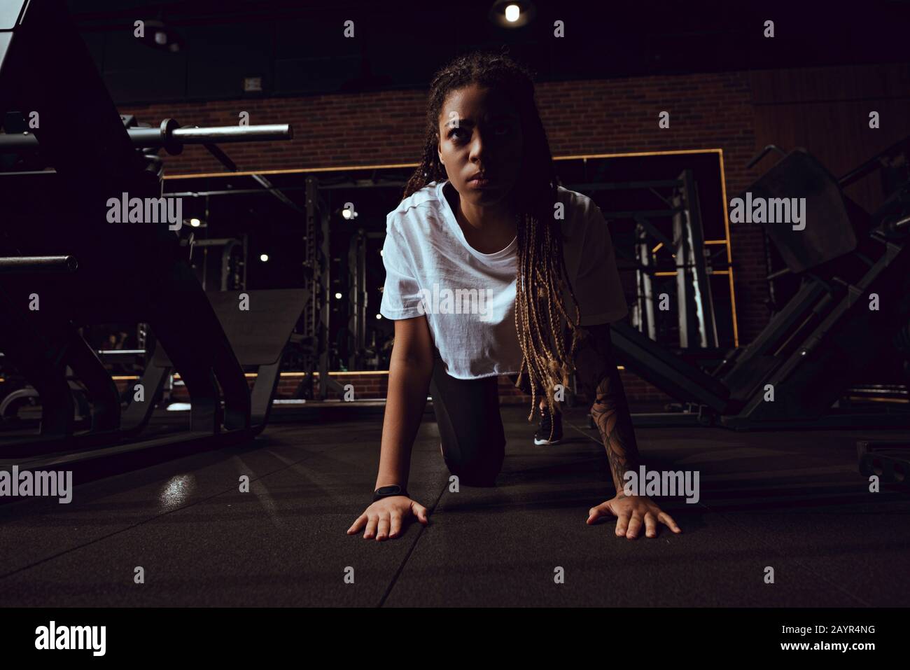 attractive african american woman with dreadlocks doing plank exercise ...