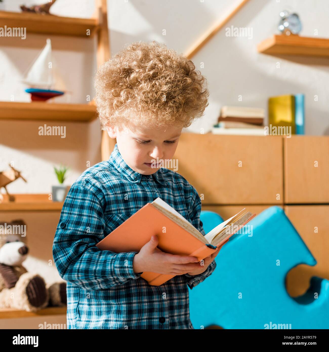 adorable and smart child reading book at home Stock Photo - Alamy
