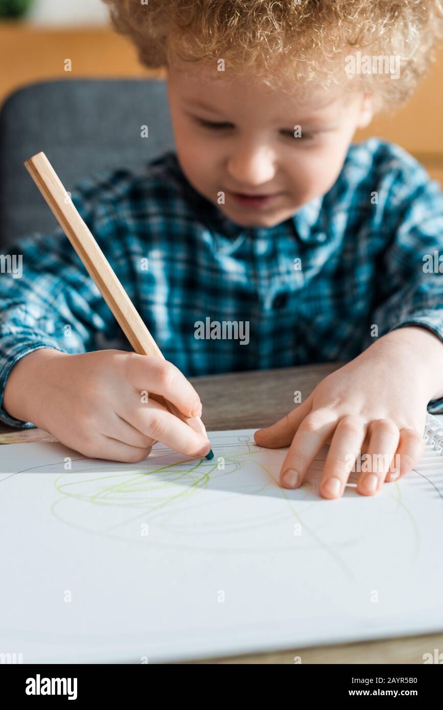 selective focus of curly child drawing on paper Stock Photo - Alamy