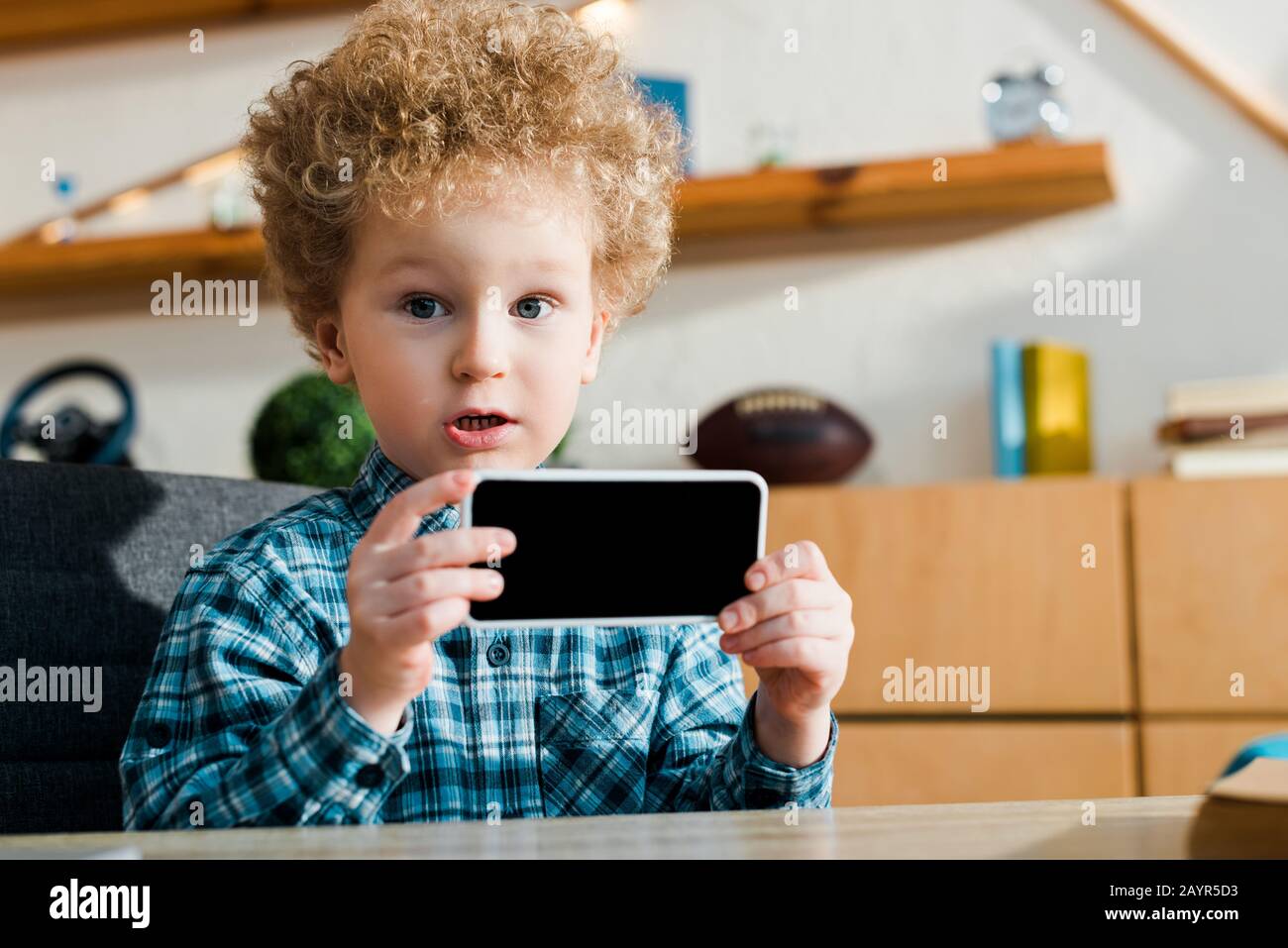 smart child holding smartphone with blank screen Stock Photo - Alamy