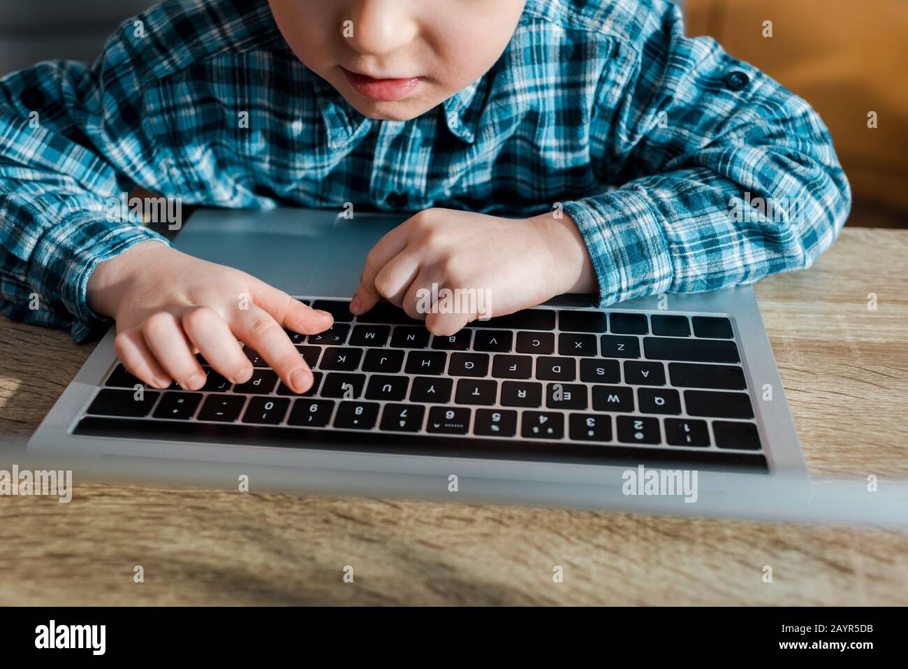 Boy typing on laptop keyboard hi-res stock photography and images - Alamy