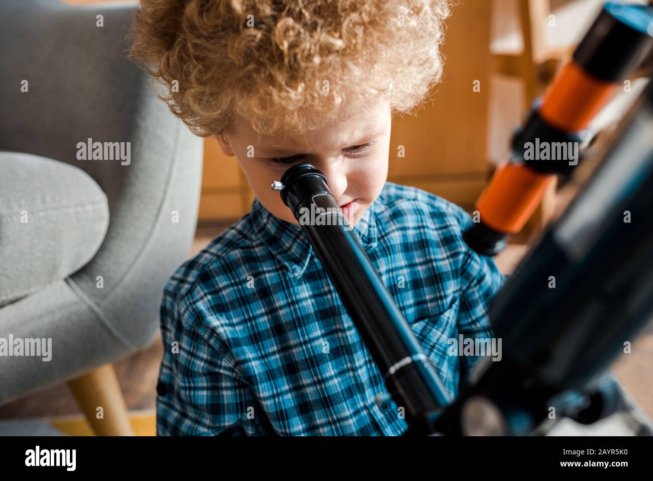 selective focus of cute and smart child looking through telescope Stock ...
