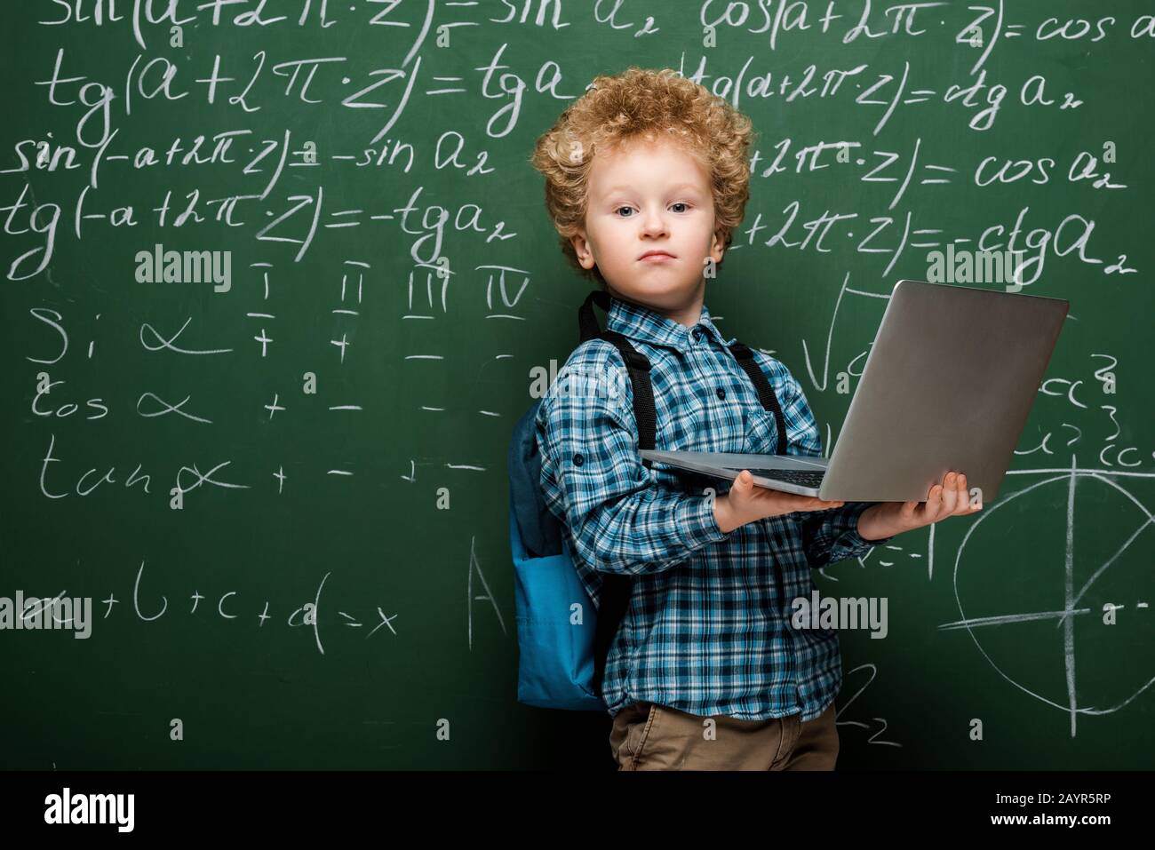 Curly kid holding laptop hi-res stock photography and images - Alamy