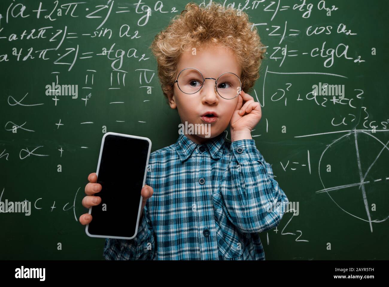 smart child holding smartphone with blank screen and touching glasses ...