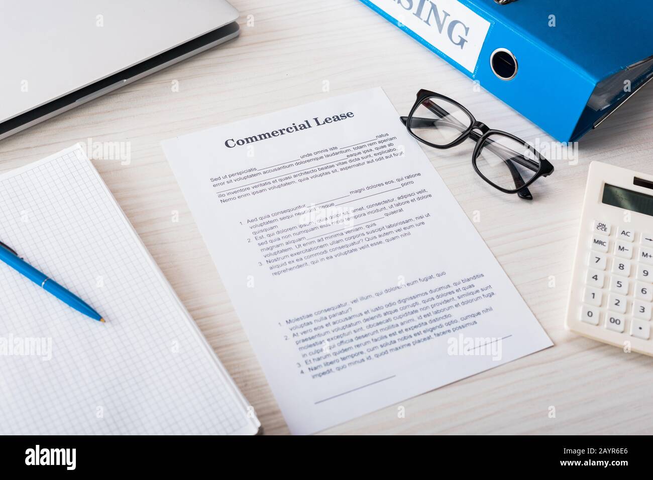 top view of folder, calculator, pen and glasses near document with ...