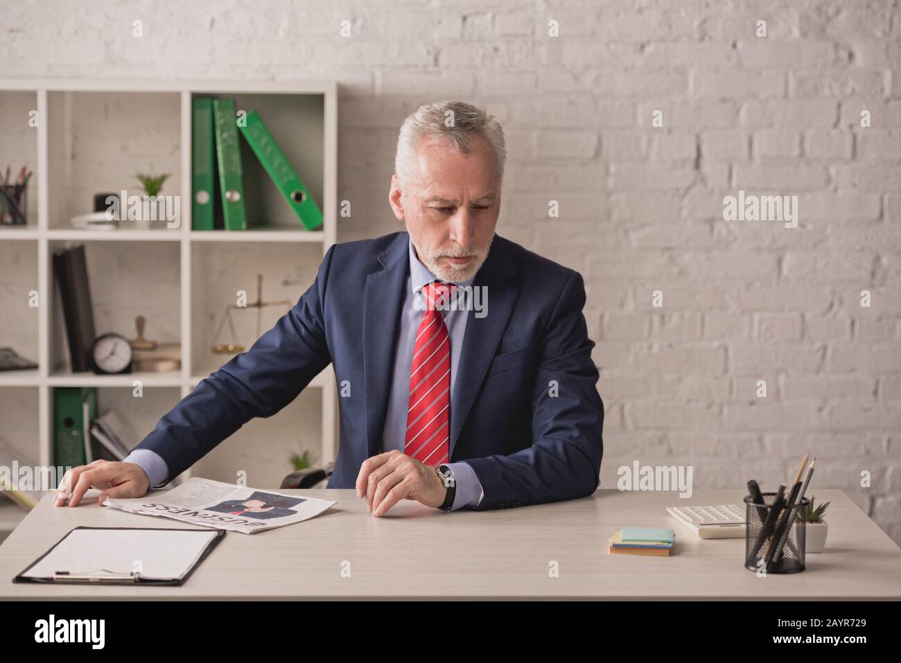 bearded realtor looking at desk with clipboard and stationery Stock ...