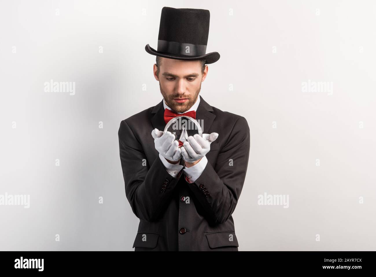professional magician looking at magic ball, isolated on grey Stock ...