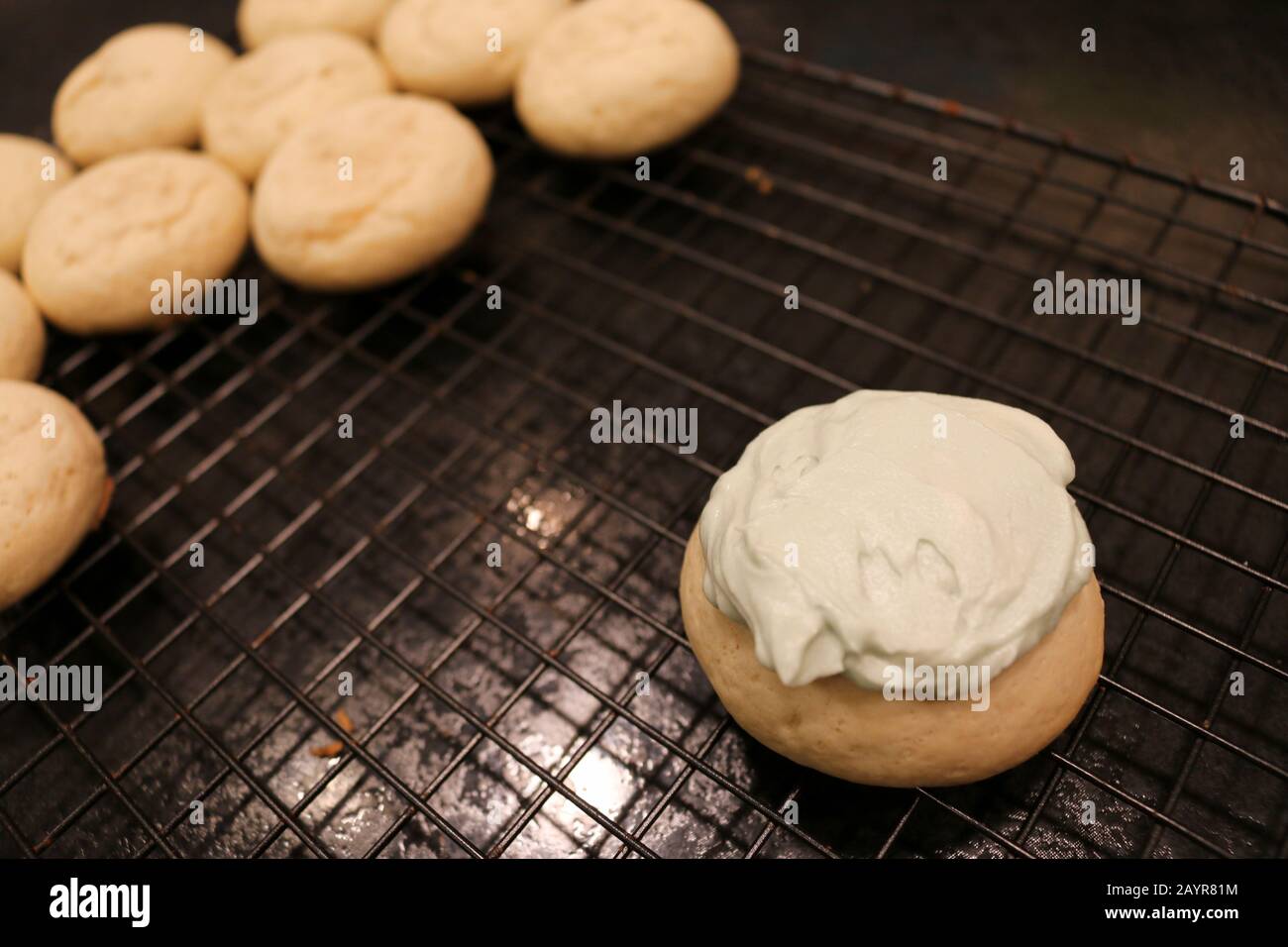Freshly Baked Sugar Cookies on wire cooling rack on black kitchen ...