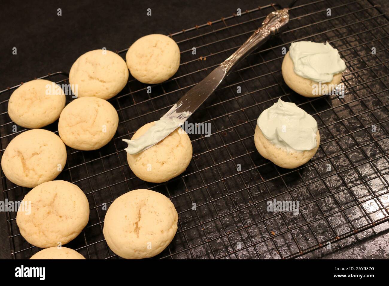 Freshly Baked Sugar Cookies on wire cooling rack on black kitchen ...
