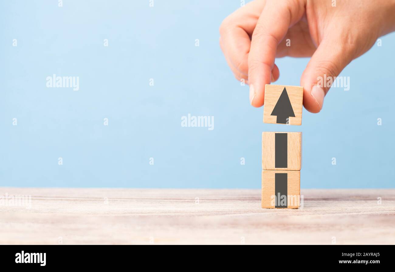 hand stacking cubes in a row, arrow symbol pointing up Stock Photo - Alamy