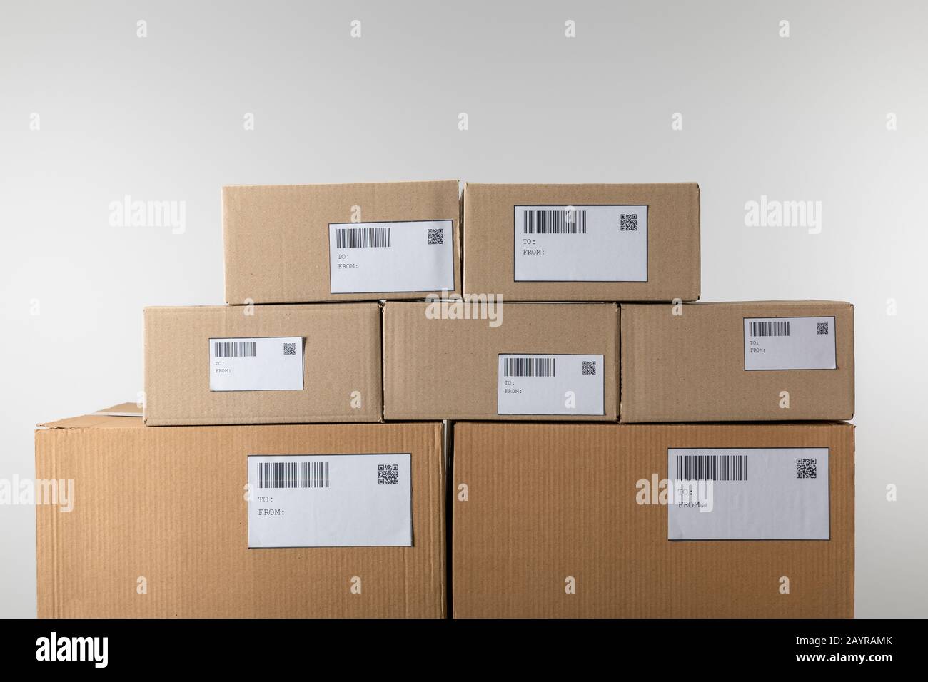 Cardboard packages with barcodes and qr codes on cards isolated on grey ...