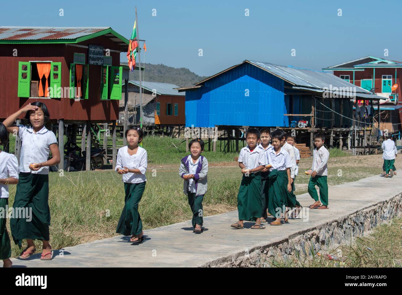 School children in school uniform lined up to great tourists at the ...